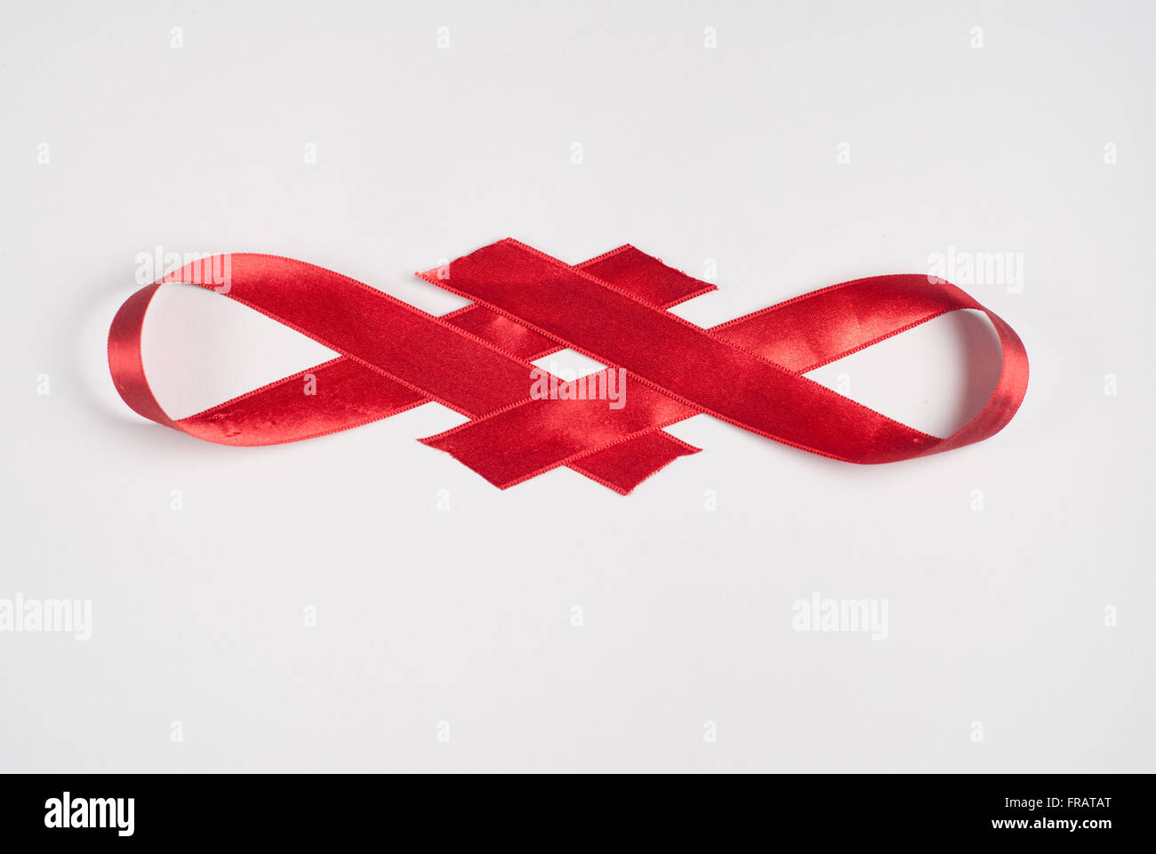 The pattern of two red, satin ribbons on a white background Stock Photo ...