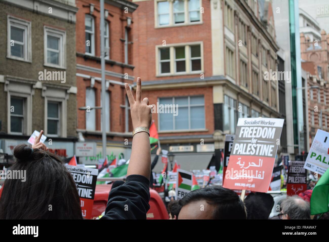 October 17th 2015. London, England. Female protester holds a 'v for ...