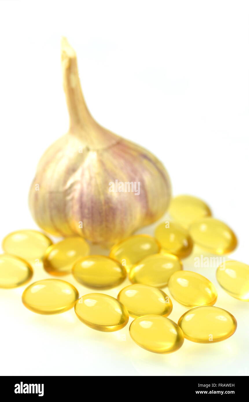fish oil capsules and garlic isolated on white background Stock Photo ...