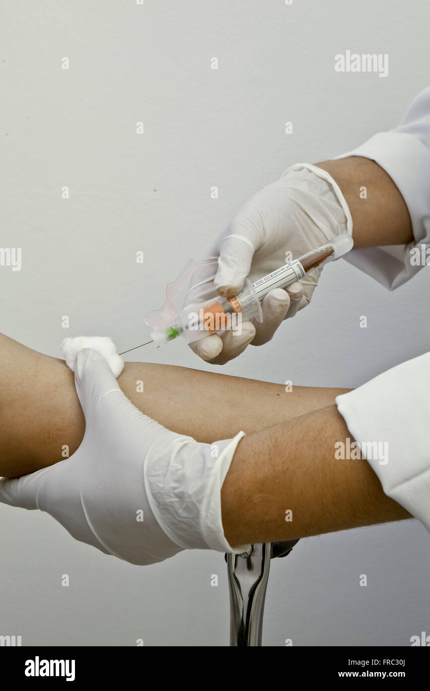 Nurse collecting blood from patient Stock Photo - Alamy