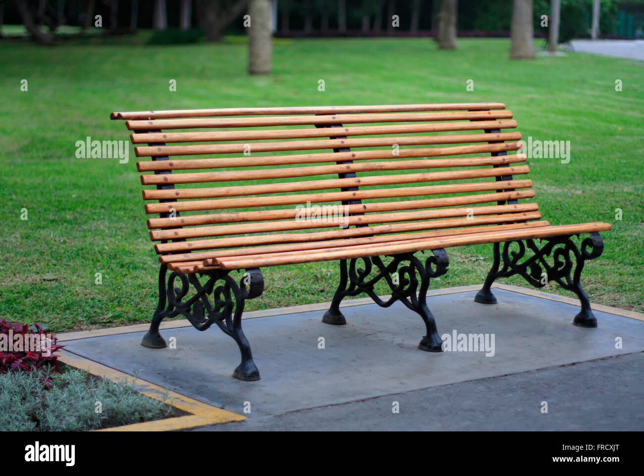 a wooden bench seat at a park Stock Photo - Alamy