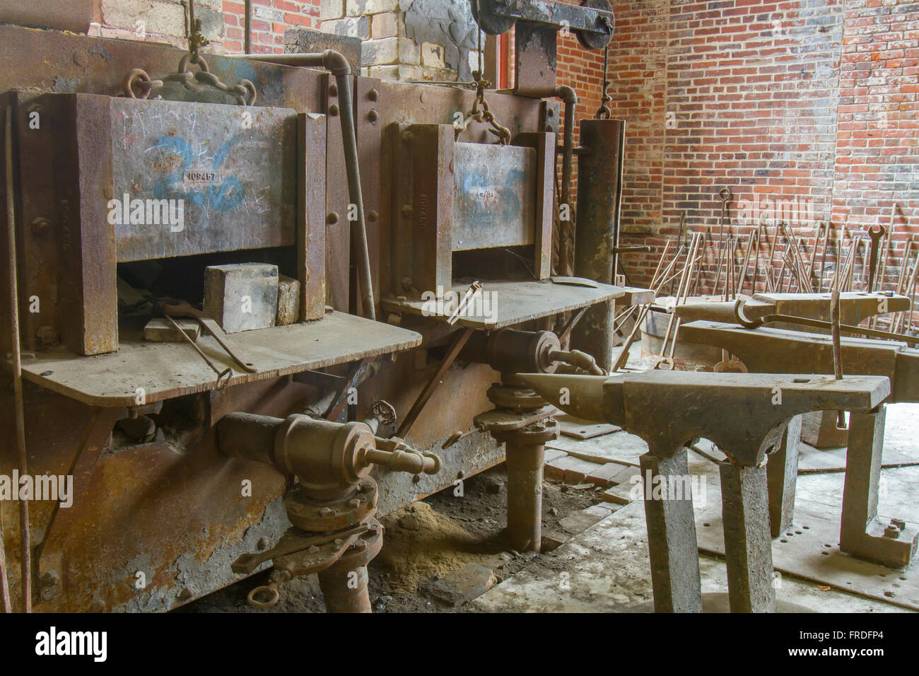 Furnaces and smithing tools inside brick blacksmith shop Stock Photo ...