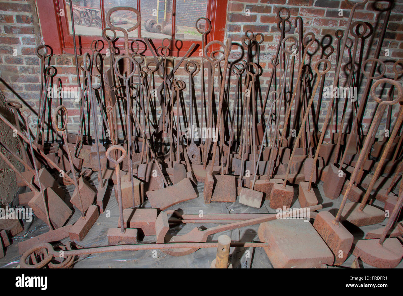 Blacksmith tools inside old brick steel mill Stock Photo - Alamy