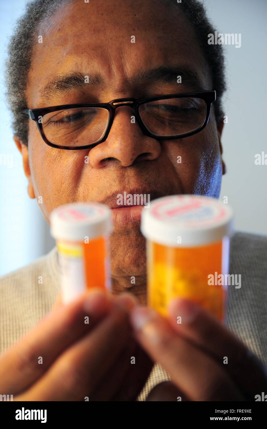African american male taking his medication Stock Photo - Alamy