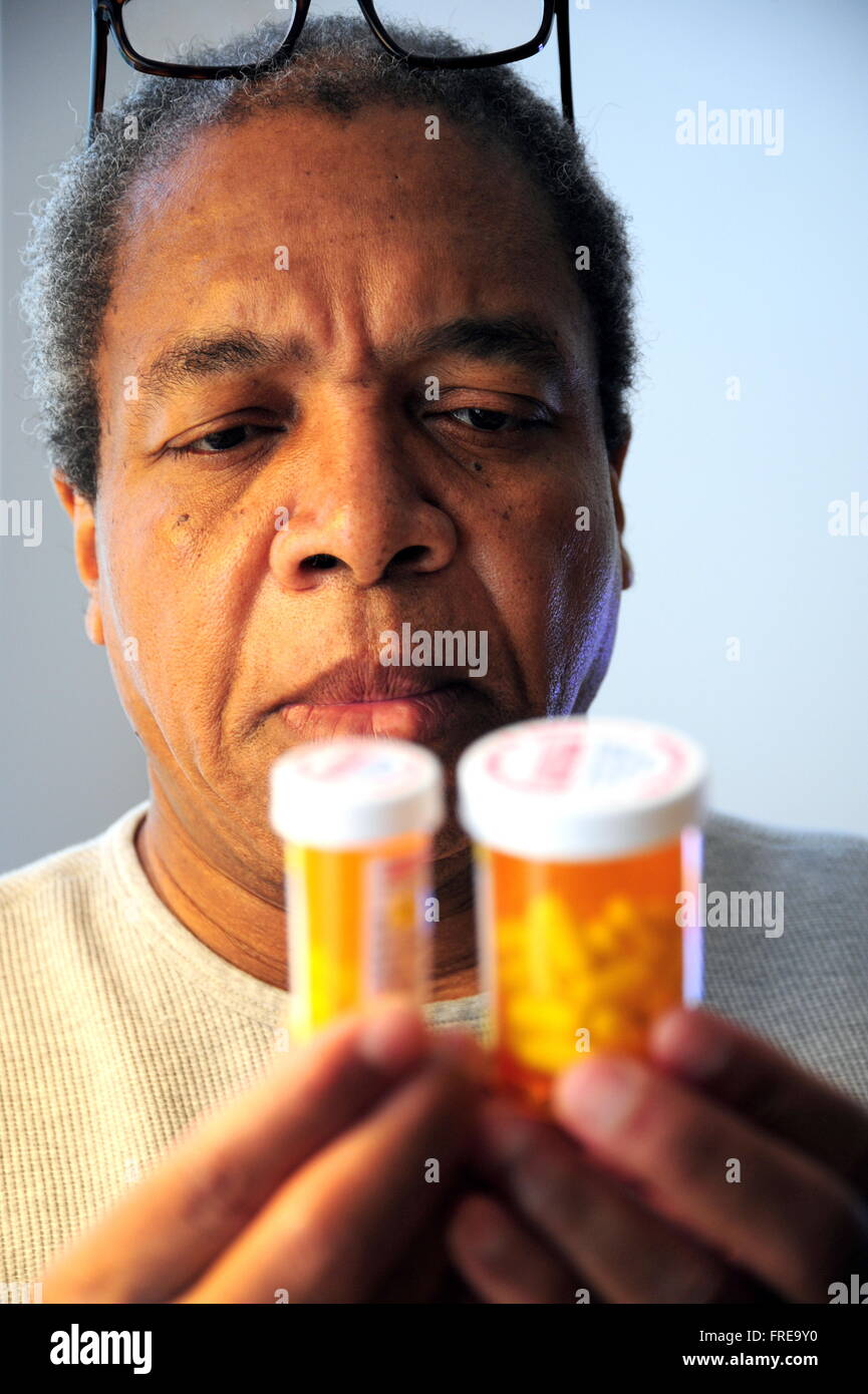 African american male taking his medication Stock Photo - Alamy