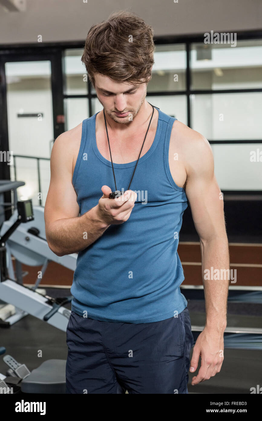 Trainer looking at a stopwatch Stock Photo - Alamy