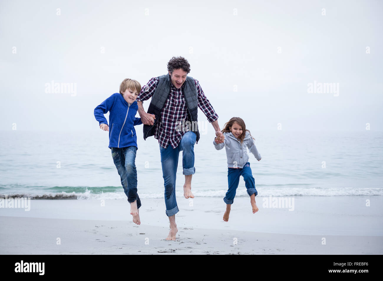Children jumping into the sea hi-res stock photography and images - Alamy
