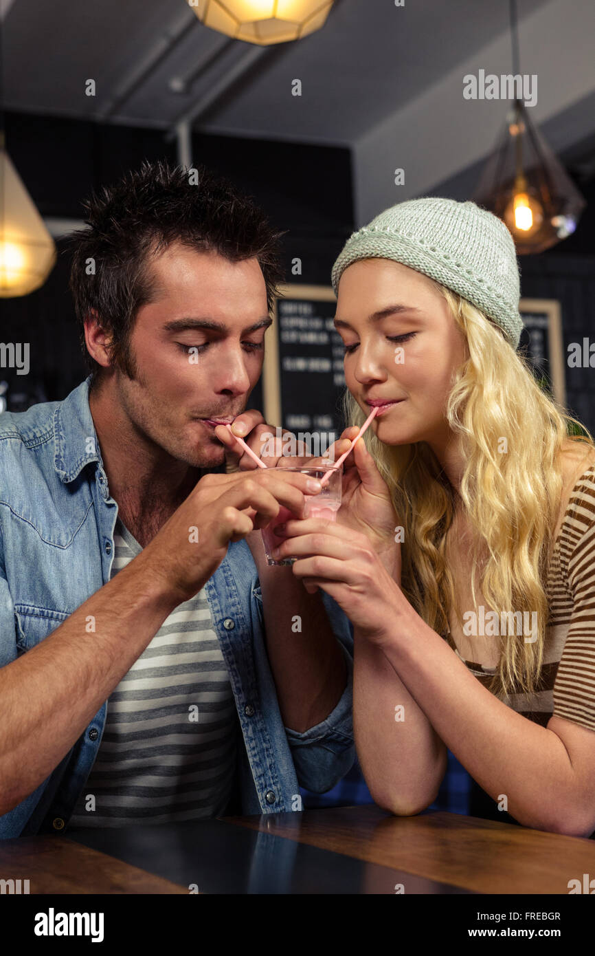 Couple sharing a milkshake Stock Photo - Alamy