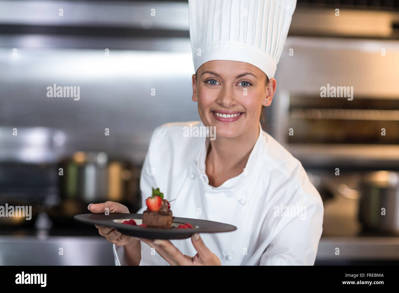 Portrait of smiling female chef holding plate Stock Photo - Alamy