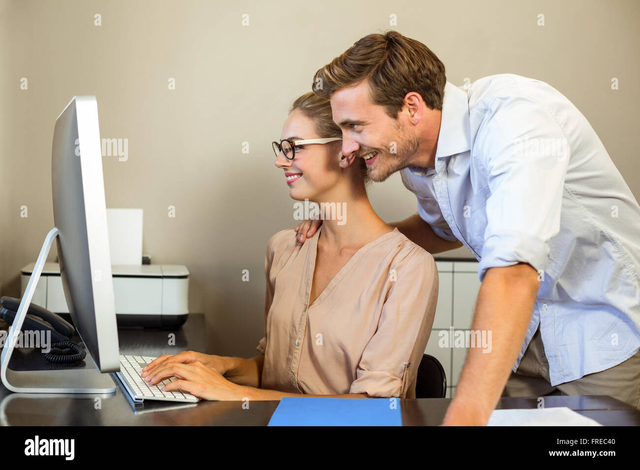 Man and woman working on computer in office Stock Photo - Alamy