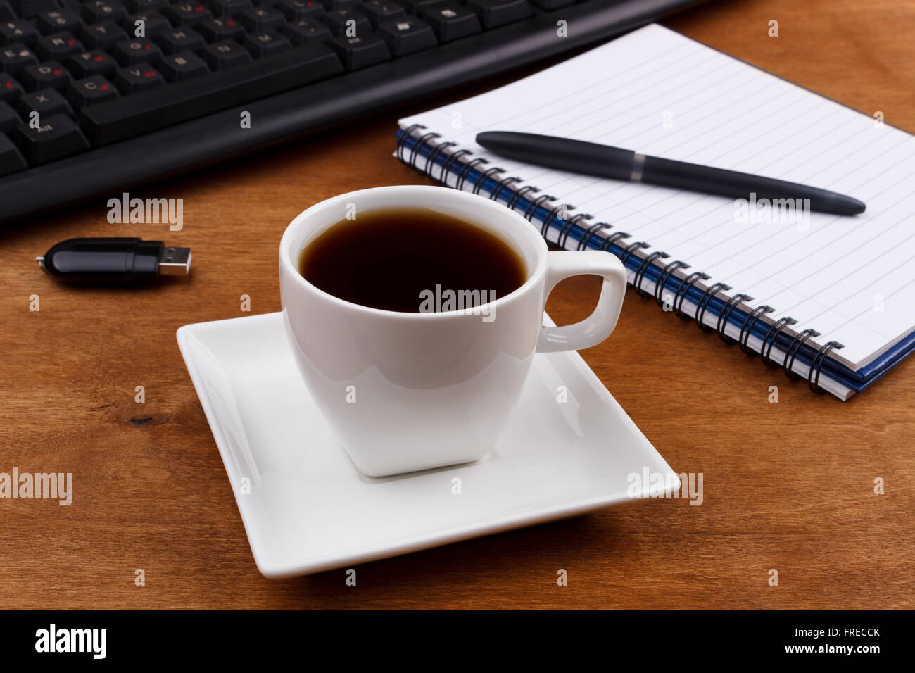 Cup of coffee on an office desk Stock Photo - Alamy