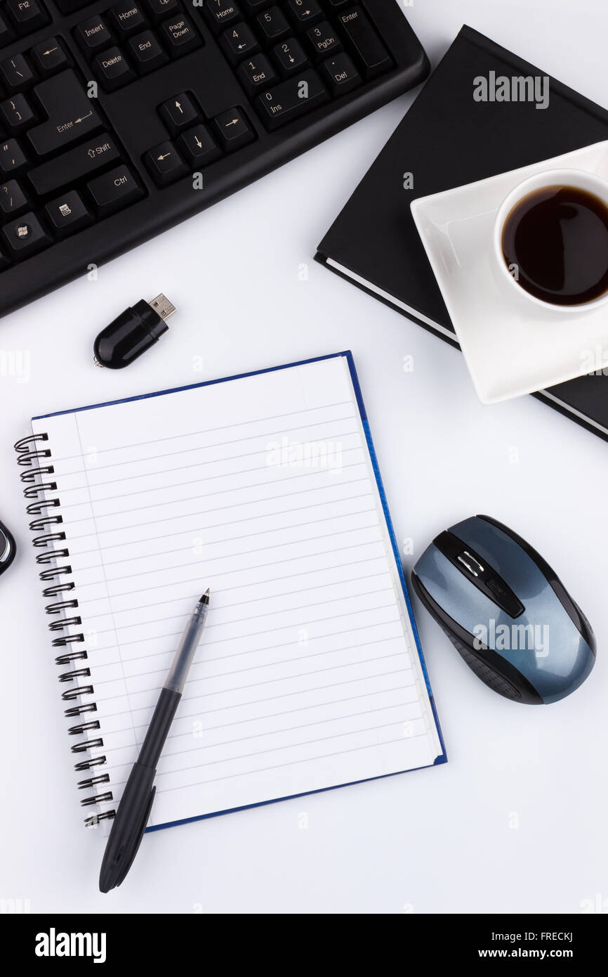 Overhead of office table with computer keyboard,mouse,USB,notepad ...