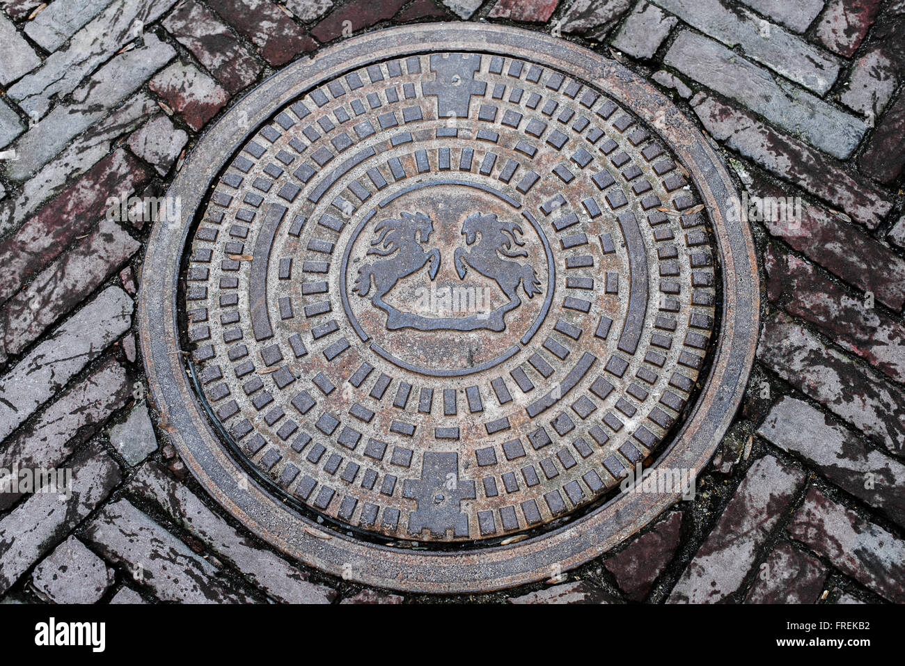 Old vintage manhole on the grey pavement Stock Photo - Alamy