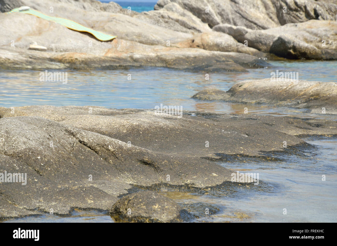 Sea rocks and shallow sea water of a bay Stock Photo - Alamy