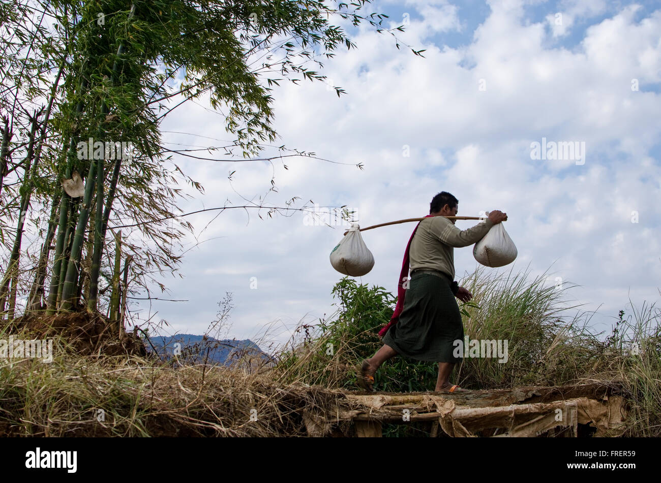 Man carrying food in Myanmar Stock Photo - Alamy