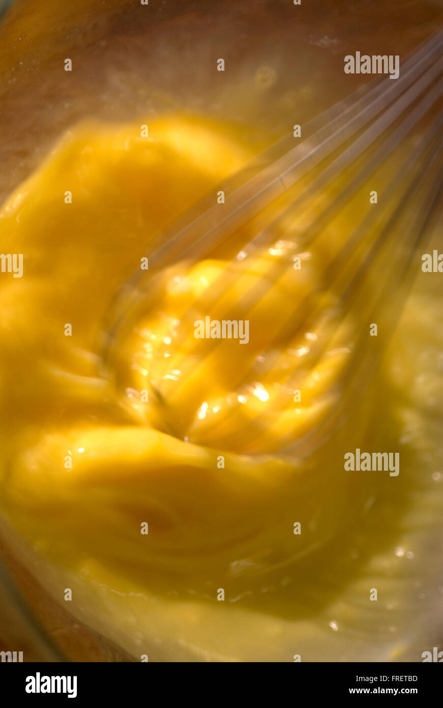Beating egg mixture with a hand whisk Stock Photo - Alamy