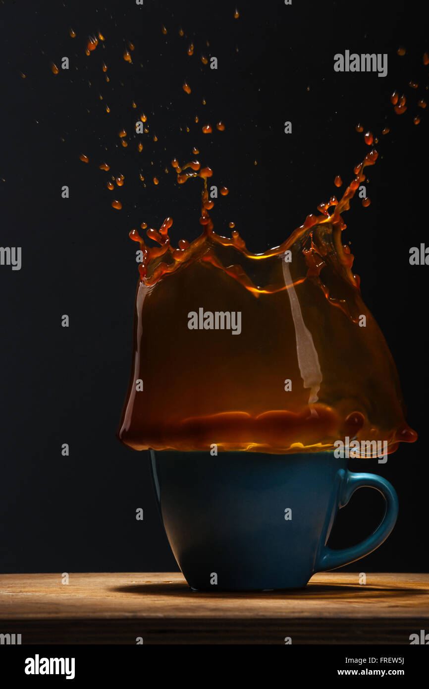 Coffee splash on dark background Stock Photo - Alamy