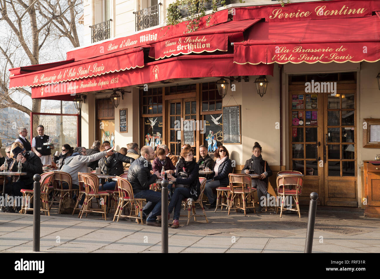Parisians in a cafe on the Ile Saint Louis in Paris France in winter ...