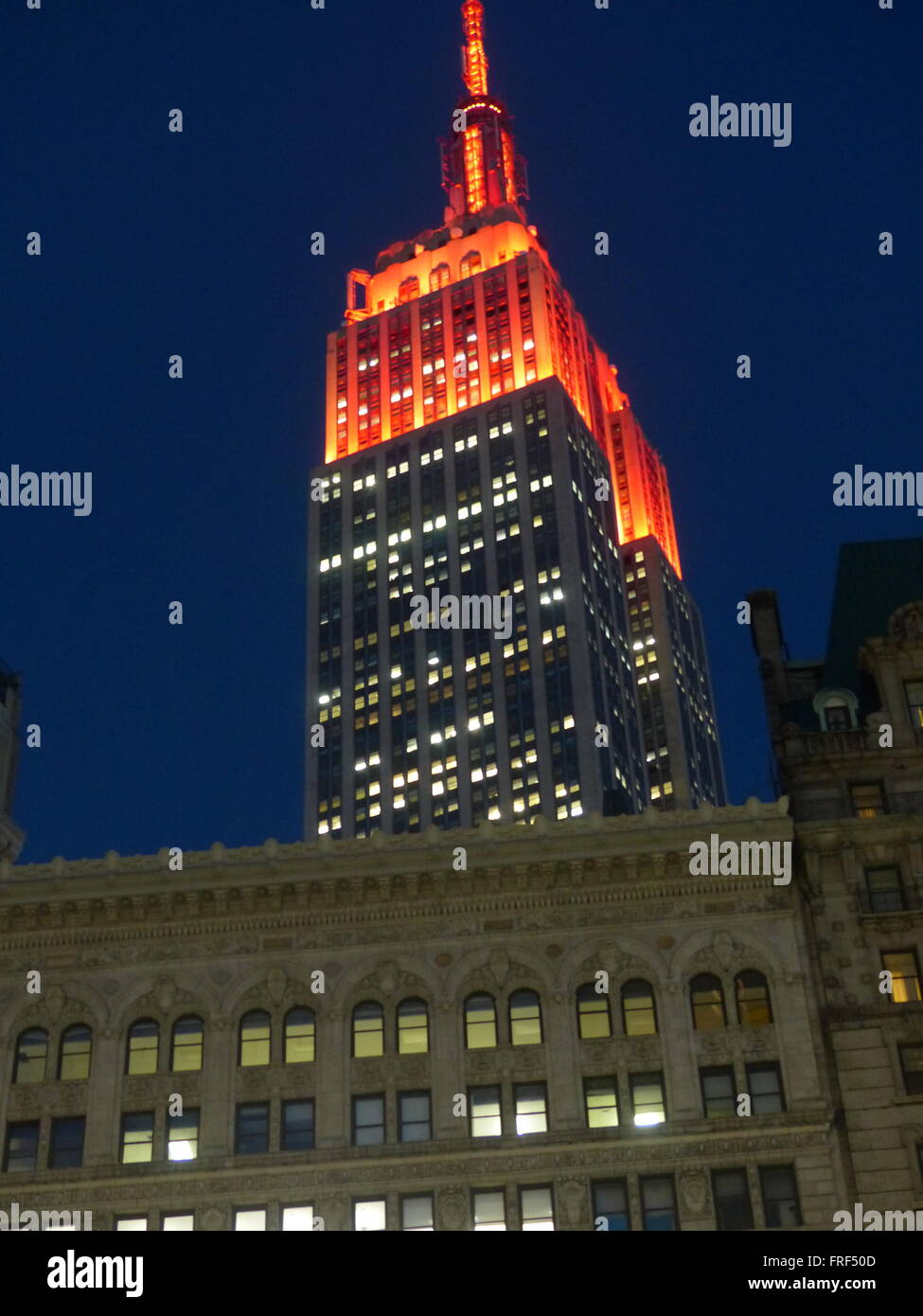 Empire State Building illuminated in red Stock Photo - Alamy