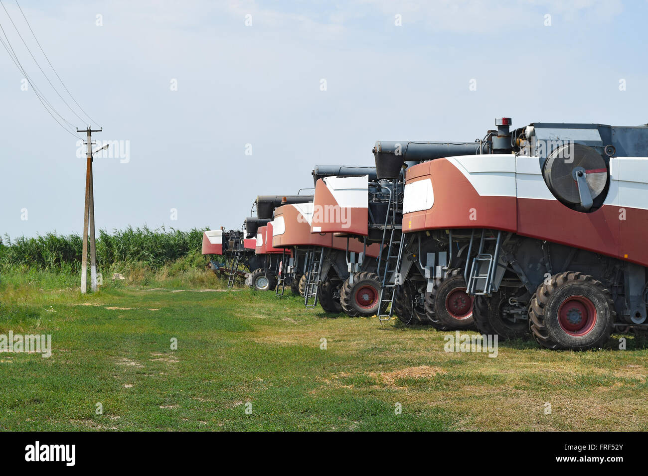 Combine harvesters, standing in a row. Agricultural machinery. Parking ... Combine harvesters, standing in a row. Agricultural machinery. Parking ...
