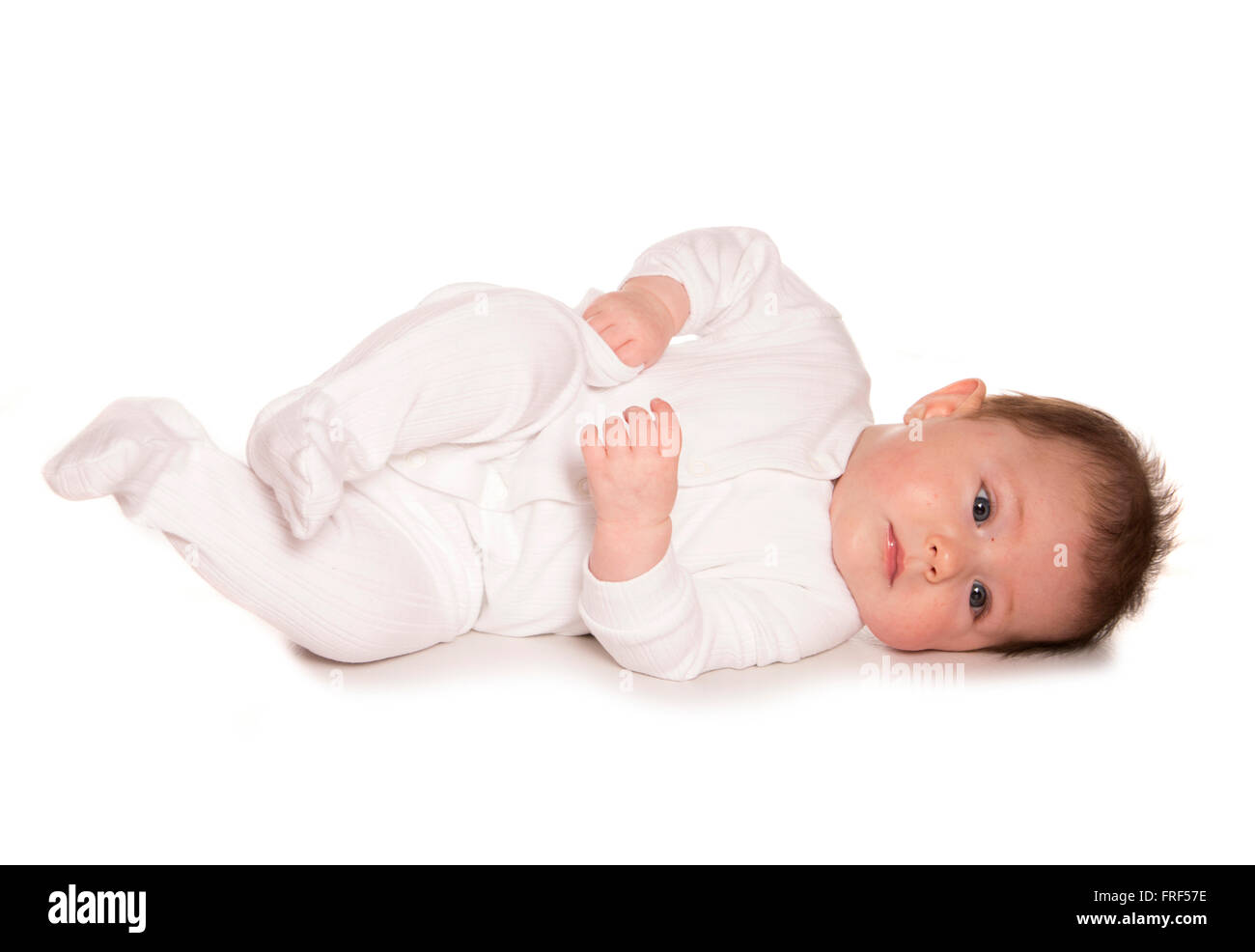 Baby learning to roll white background Stock Photo - Alamy