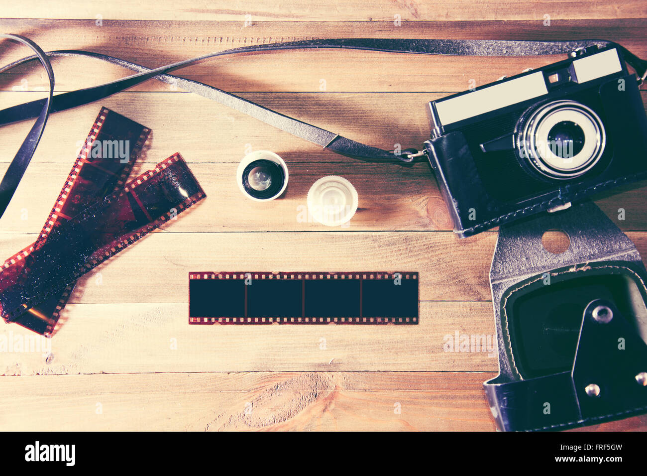 Retro vintage camera and photographic film on wooden background ...