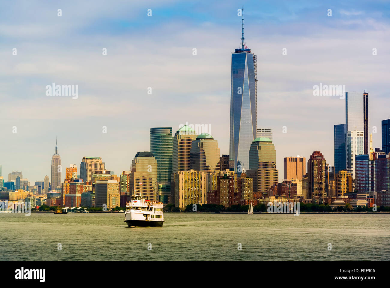 Lower Manhattan skyline and Statue Cruises boat in Upper Bay, New York ...