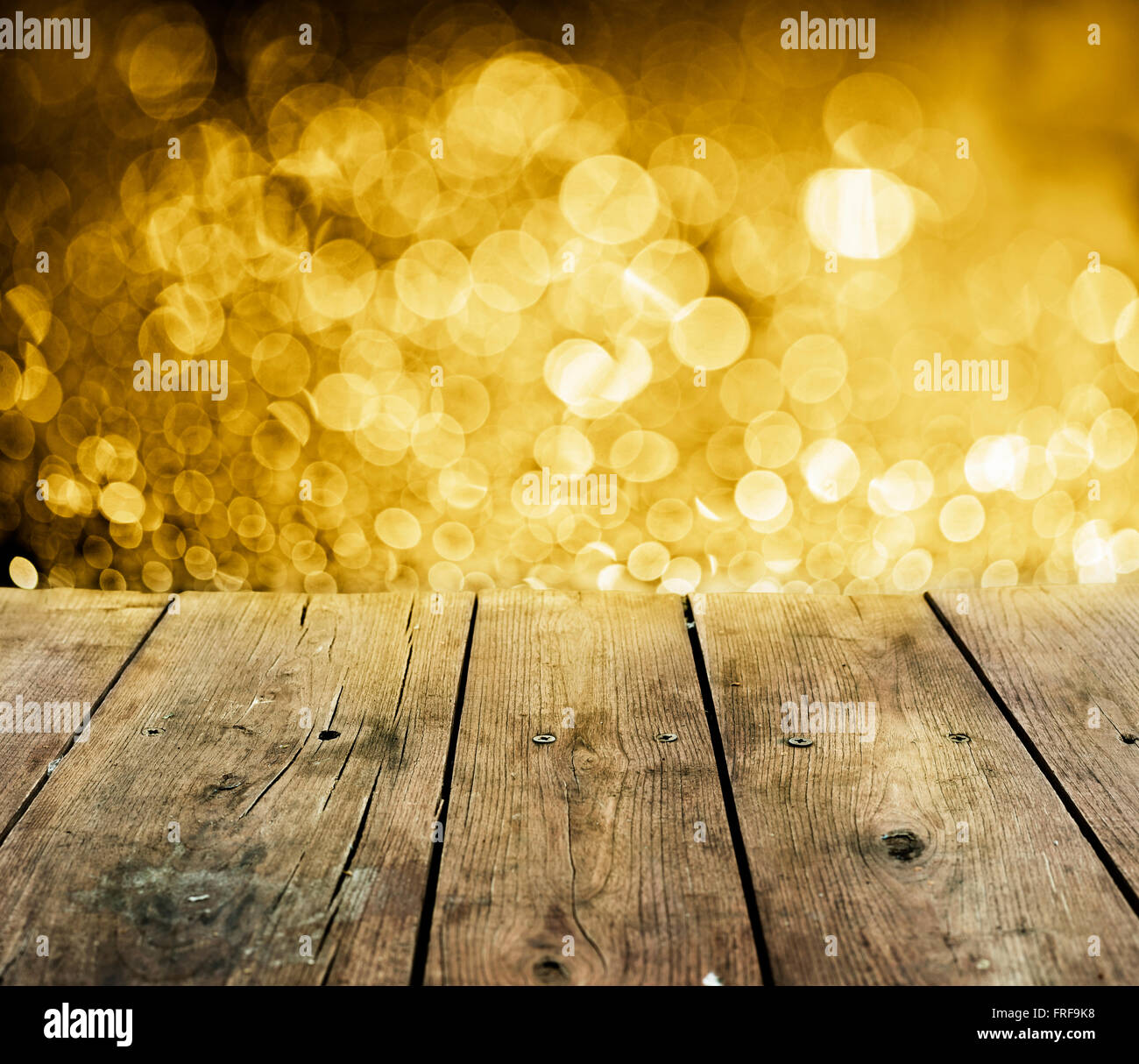 Empty wooden table with christmas lights behind Stock Photo - Alamy