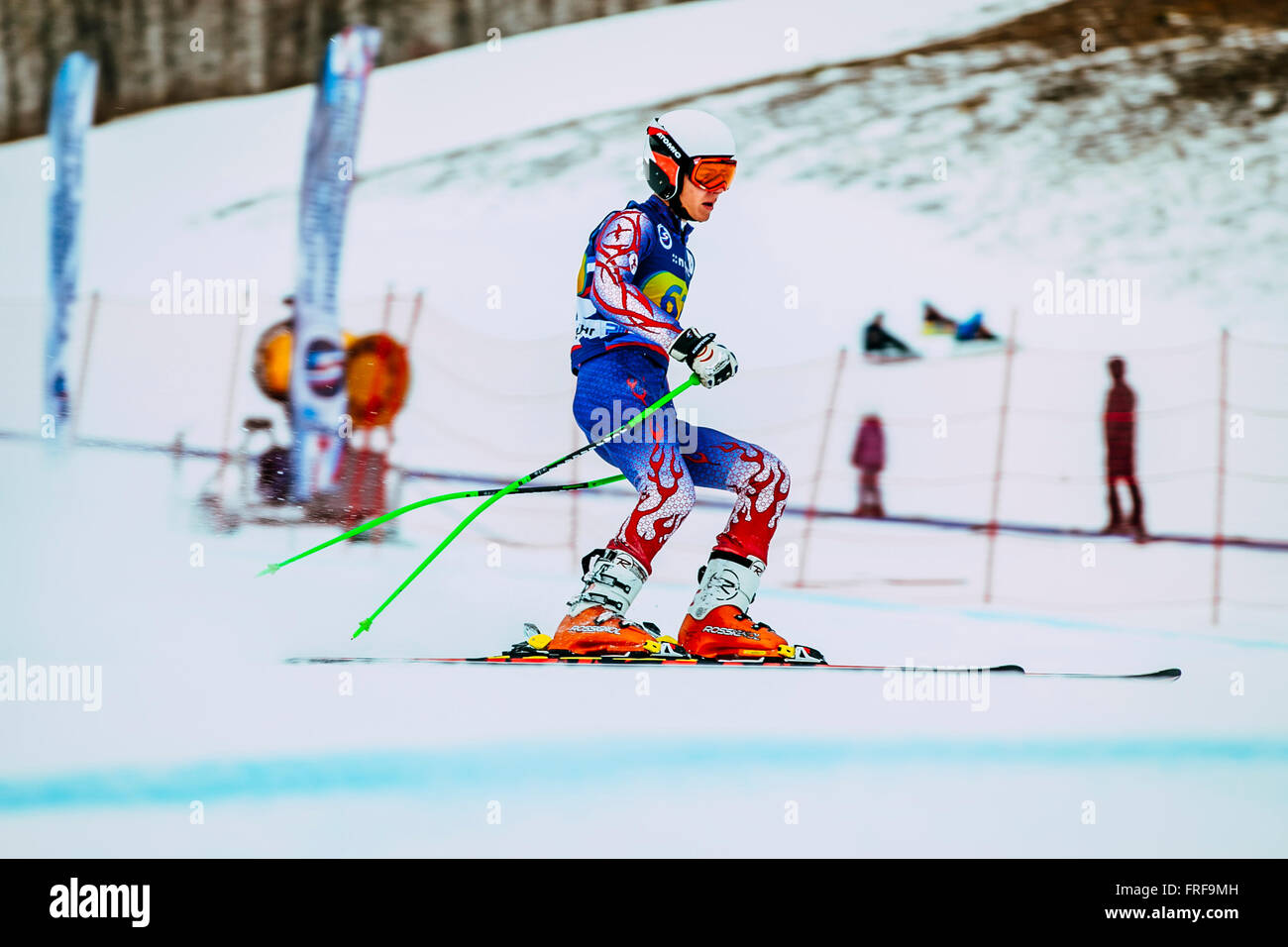 athlete male skier after finish of race downhill from mountains during ...