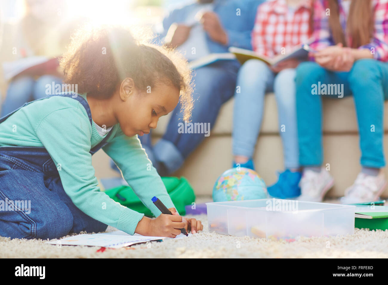 Little girl drawing with highlighter Stock Photo - Alamy