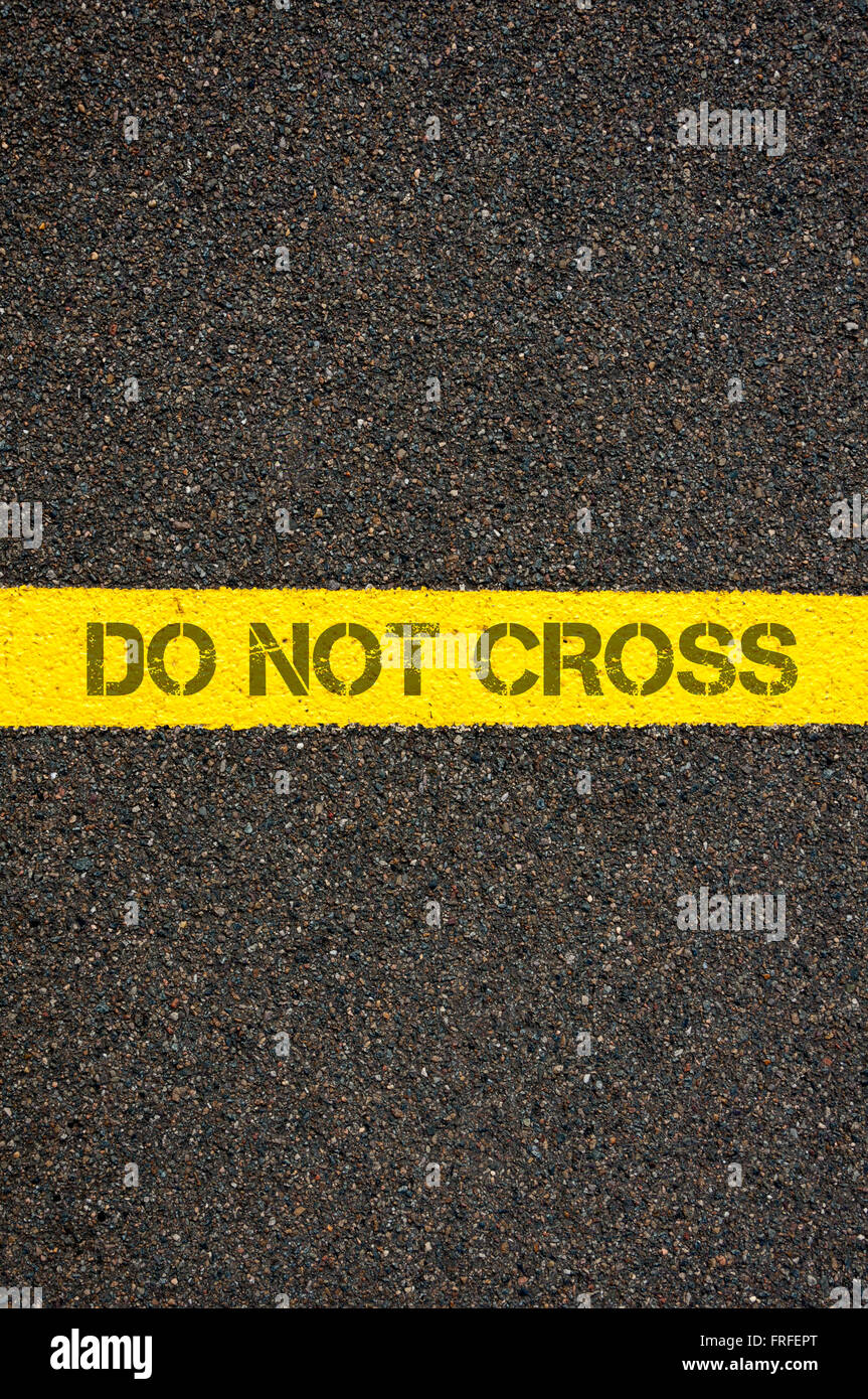 Road marking yellow paint dividing line with words DO NOT CROSS ...