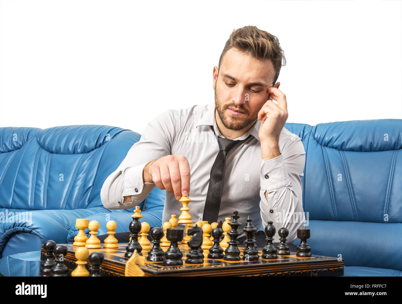 Portrait of a handsome young man playing chess Stock Photo - Alamy
