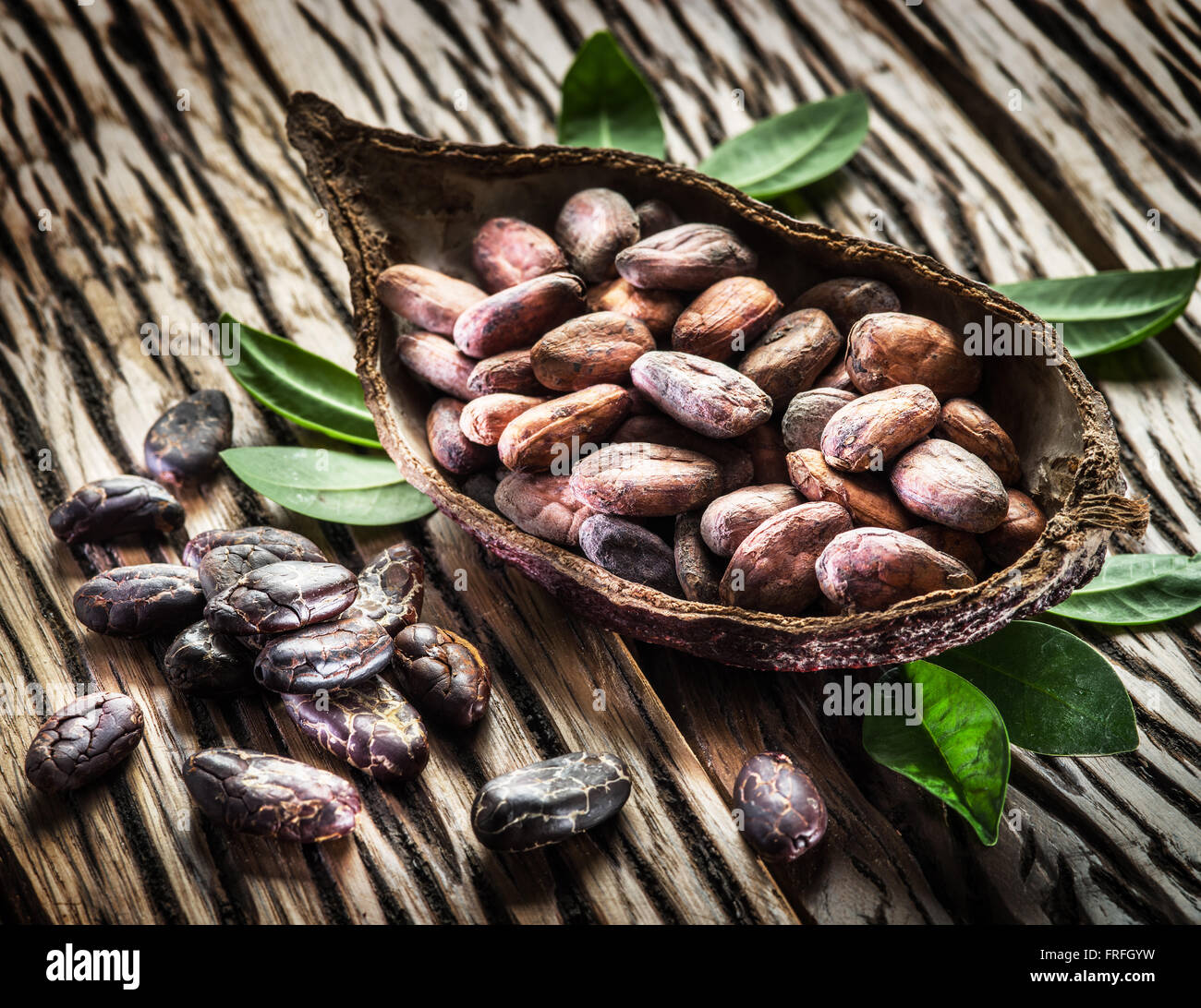 Cocoa pod and cocoa beans on the wooden table Stock Photo - Alamy