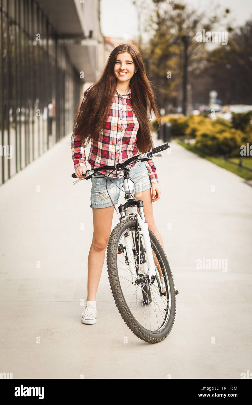 Young beautiful woman on a bicycle Stock Photo - Alamy