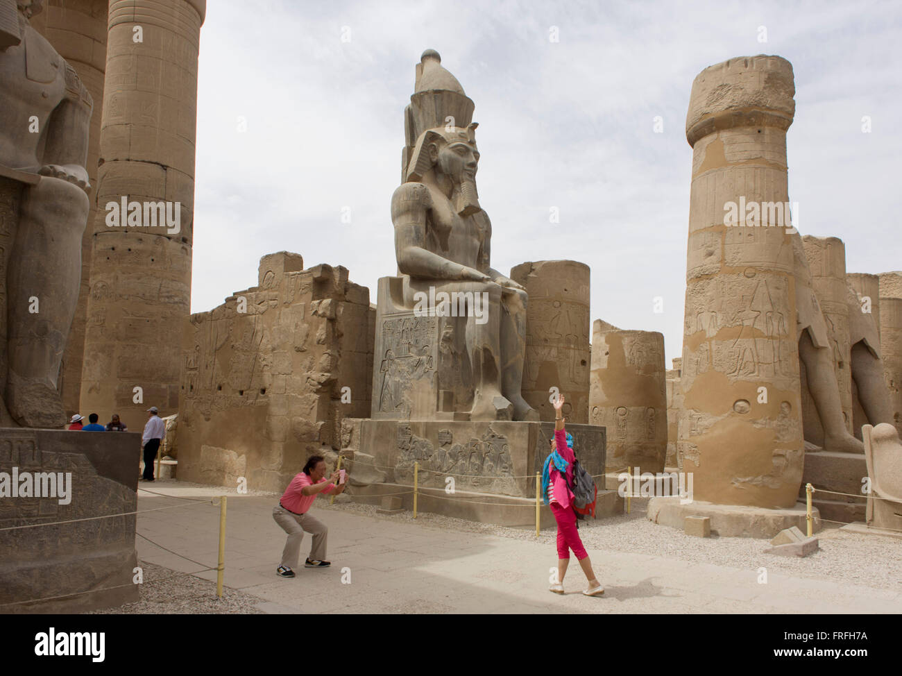 Tourist groups stand and photograph beneath the giant colossus in the ...