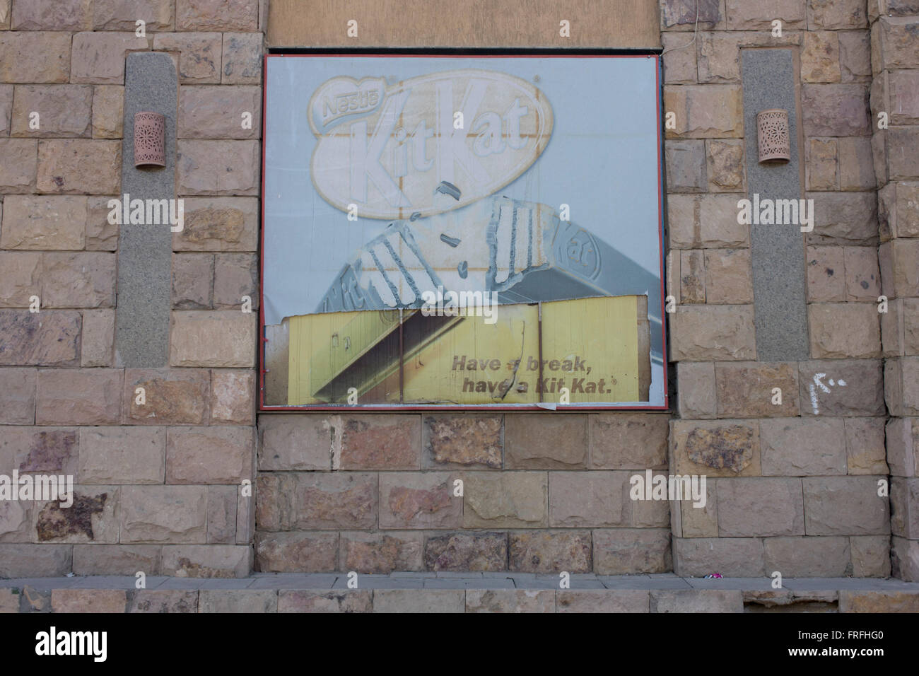 A detail of a faded Kit-Kat chocolate poster outside the ancient ...