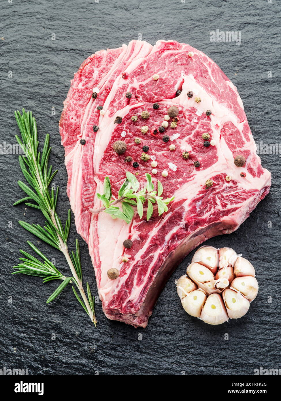Rib eye steak with spices on the black background Stock Photo - Alamy