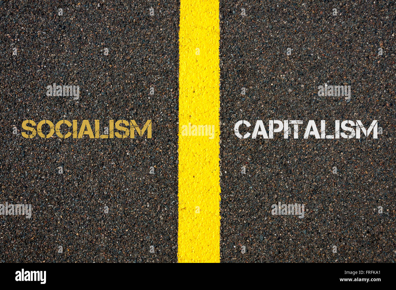Antonym concept of SOCIALISM versus CAPITALISM written over tarmac ...