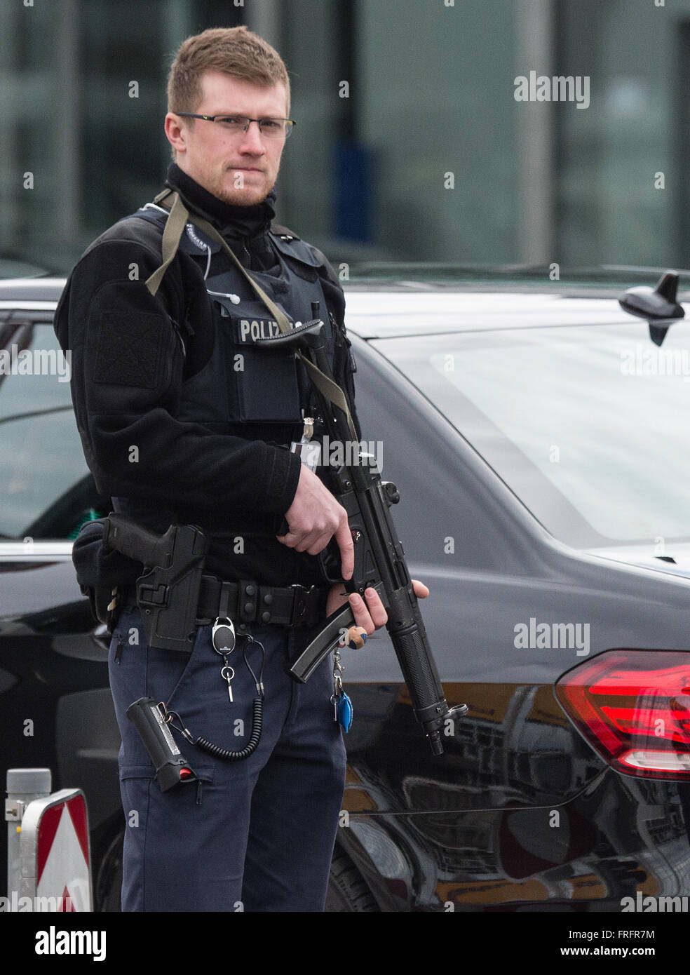 A member of the German police carrying a submachine gun secures the ...