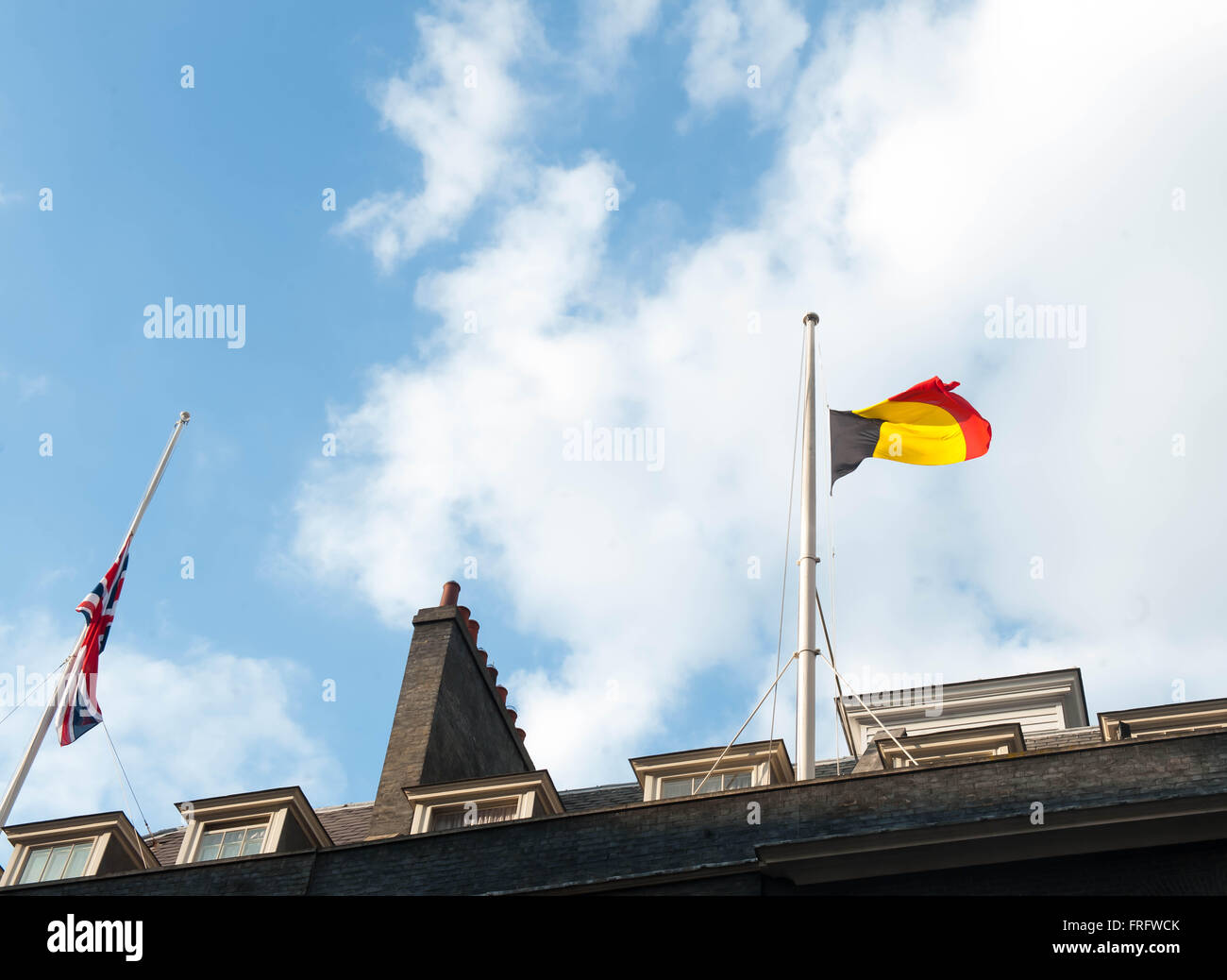 London UK. 22nd March 2016 The Union Flag & Belgium Flag lowered to ...