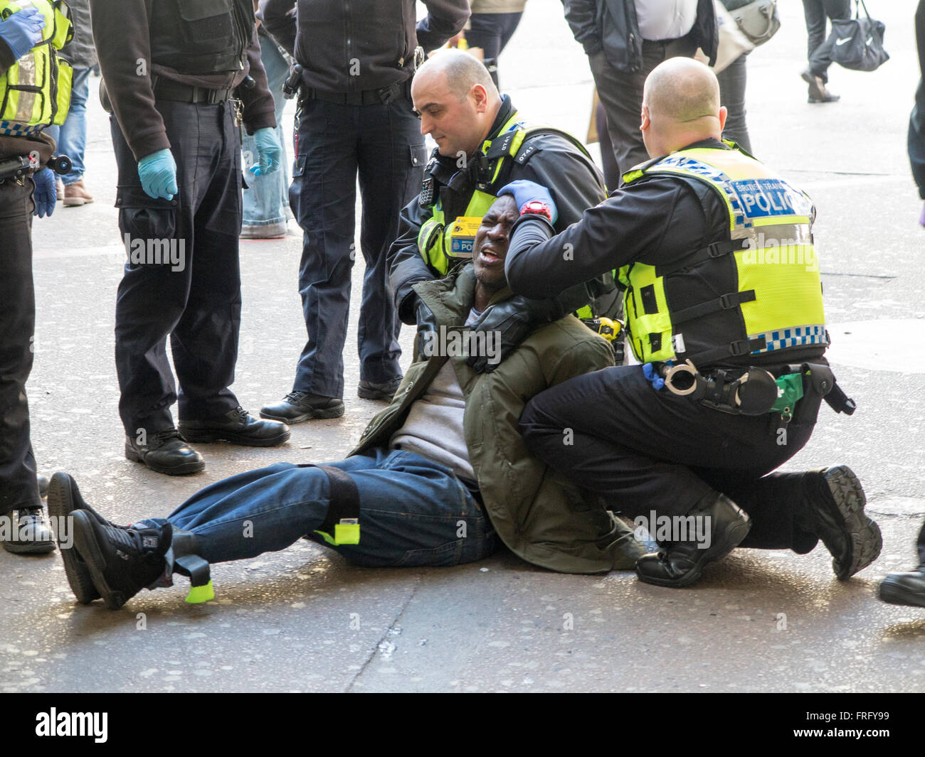 London, UK. 22nd Mar, 2016. A man is arrested outside Victoria station ...