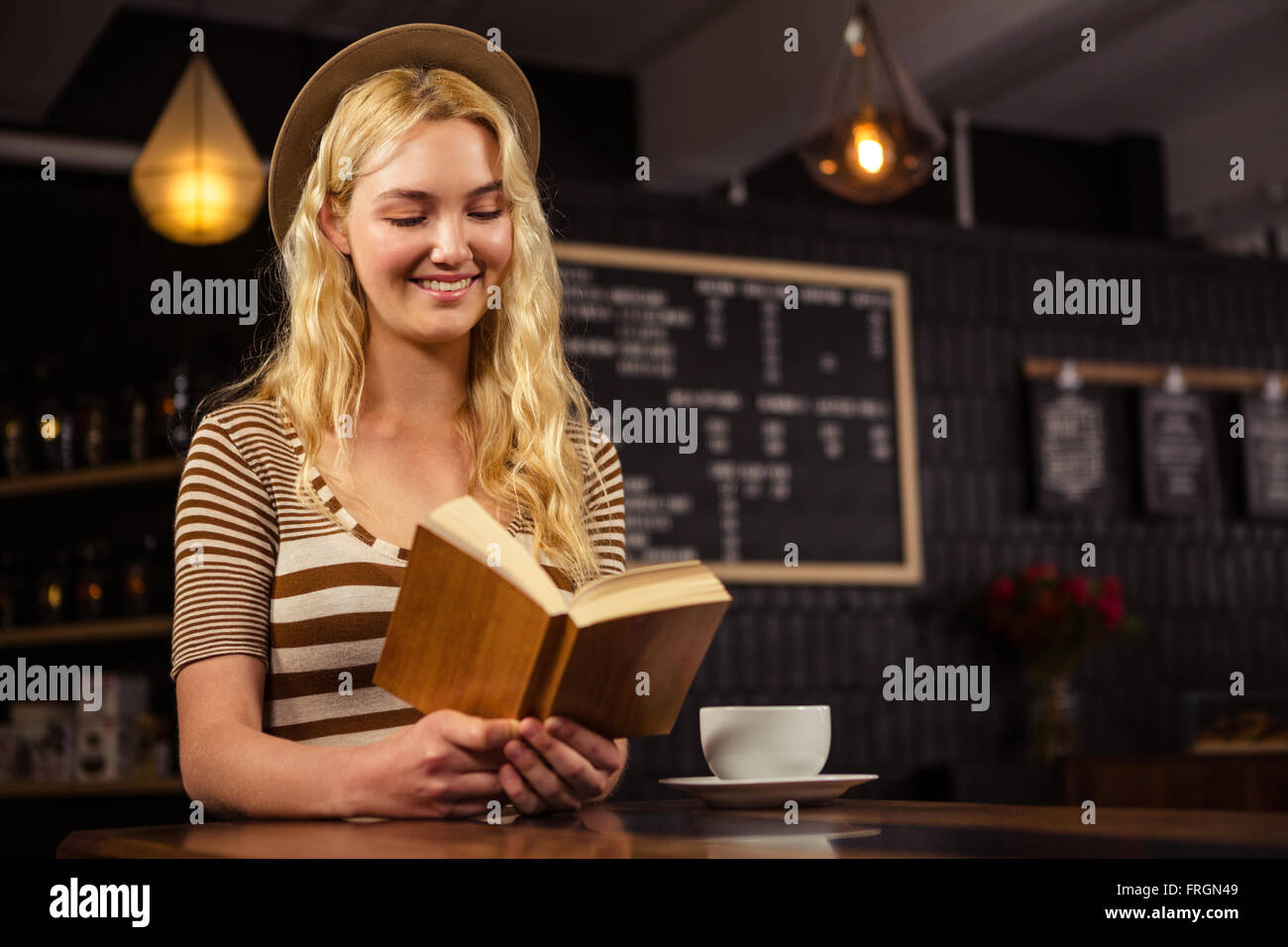 Smiling woman reading a book Stock Photo - Alamy