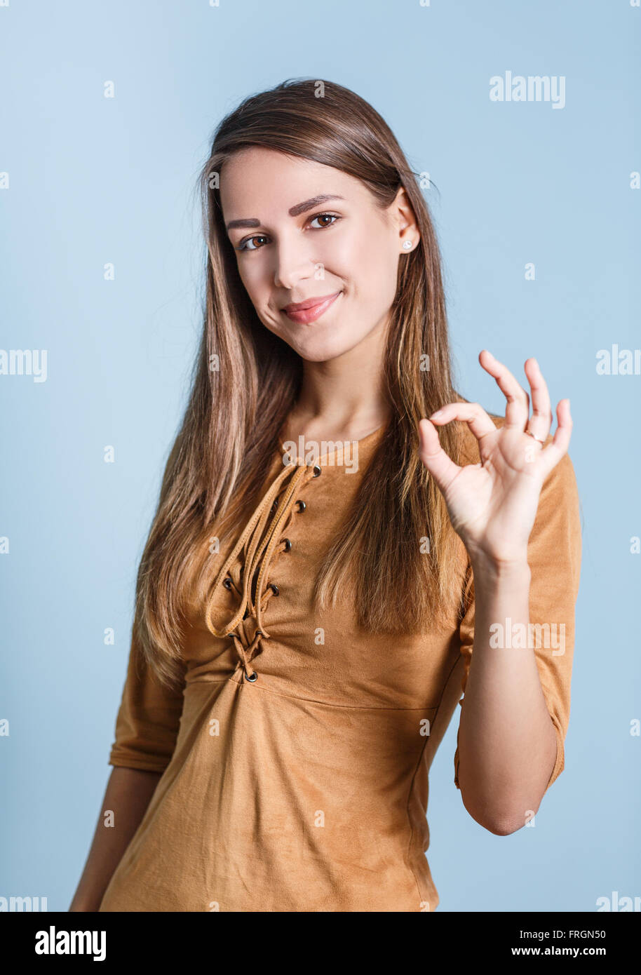 Young beautiful woman shows OK sign Stock Photo - Alamy