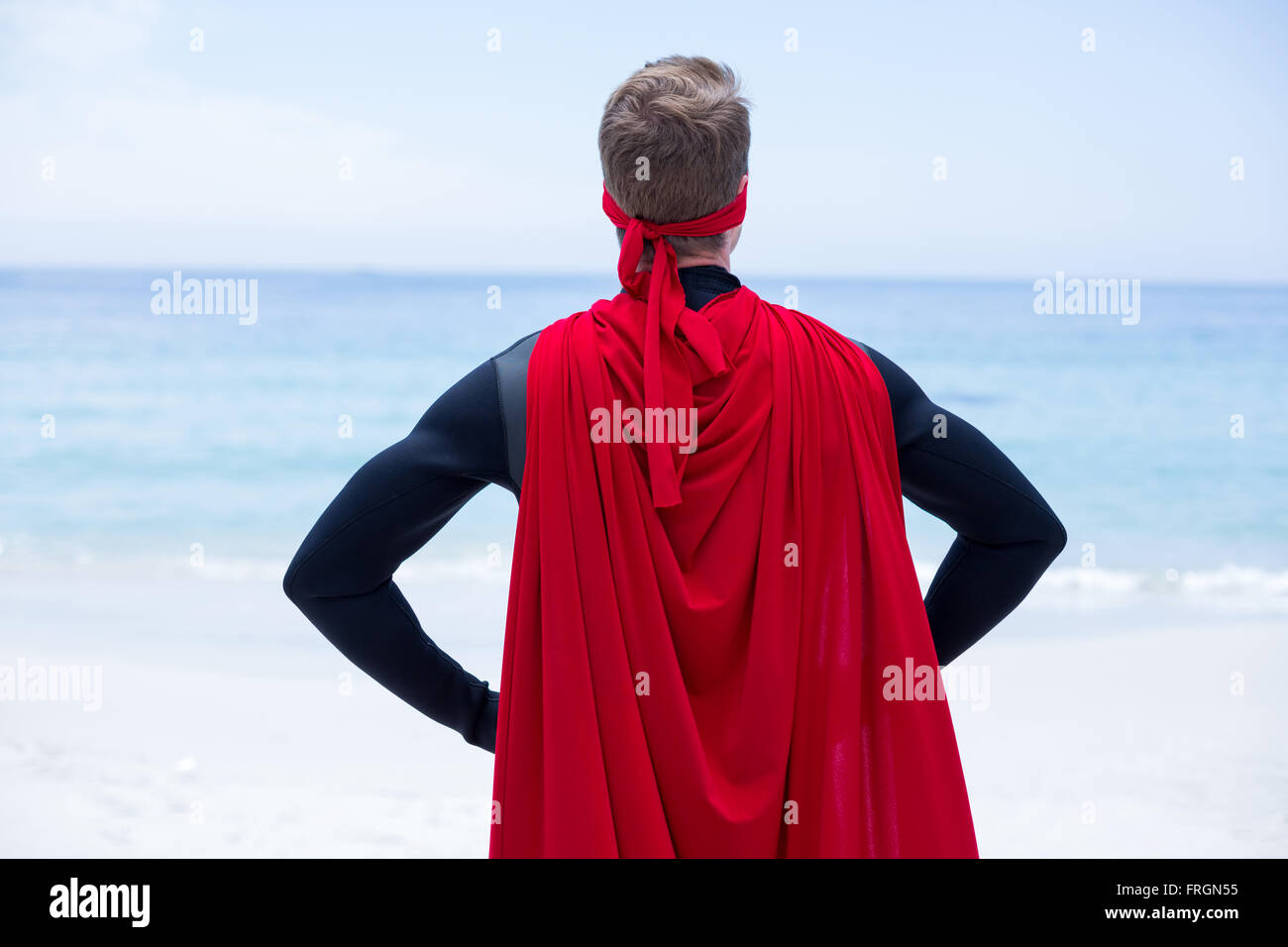 Superhero costume with hand on hip at sea shore Stock Photo - Alamy