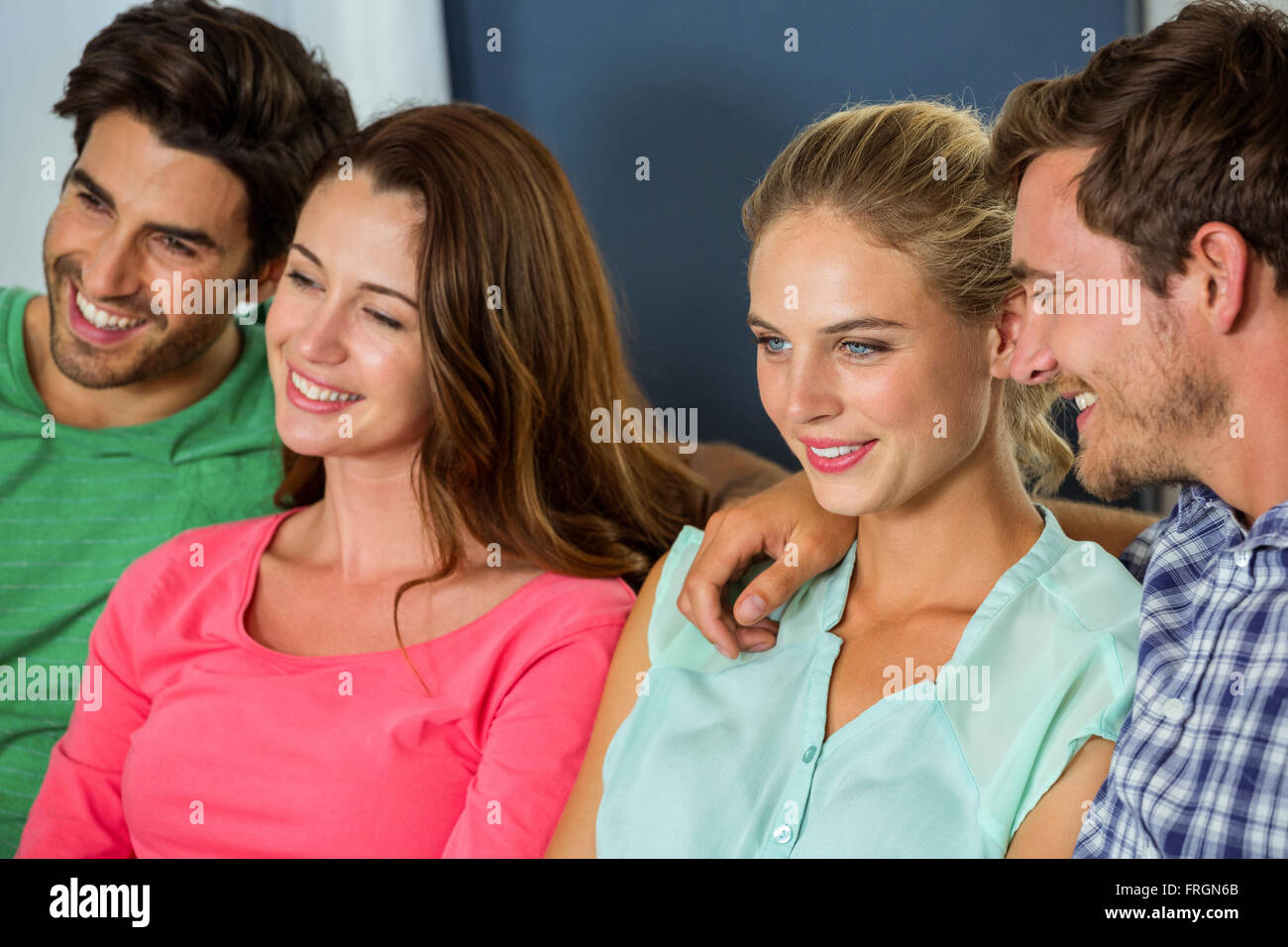 Group of happy friends sitting together Stock Photo - Alamy