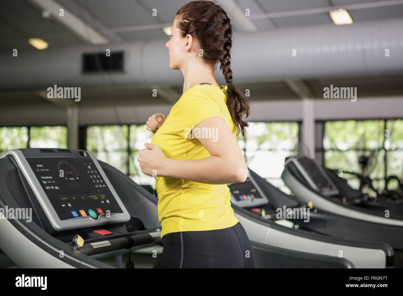 Woman jogging on treadmill Stock Photo - Alamy