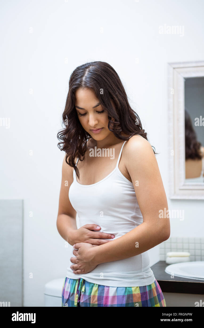Young woman touching her belly Stock Photo - Alamy
