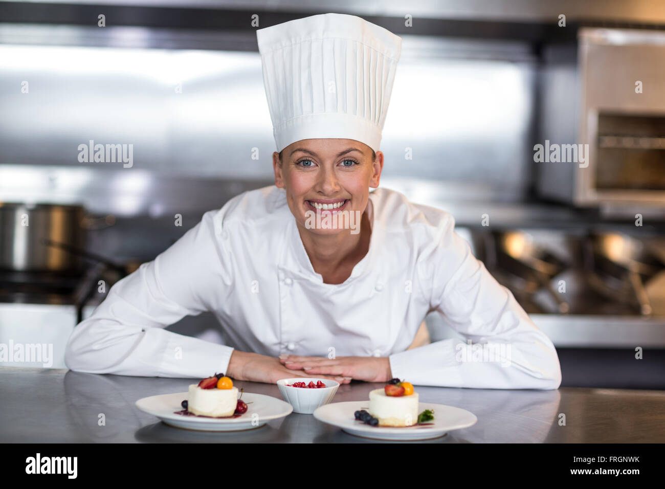 Portrait of happy female chef in kitchen Stock Photo - Alamy