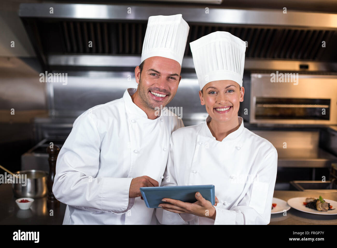 Portrait of happy chefs holding clipboard in kitchen Stock Photo - Alamy