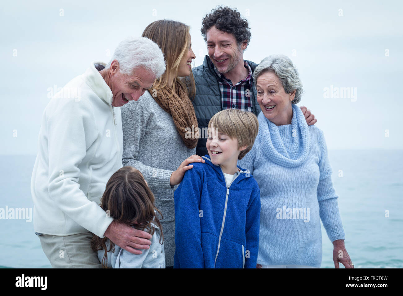 Family standing at beach Stock Photo - Alamy